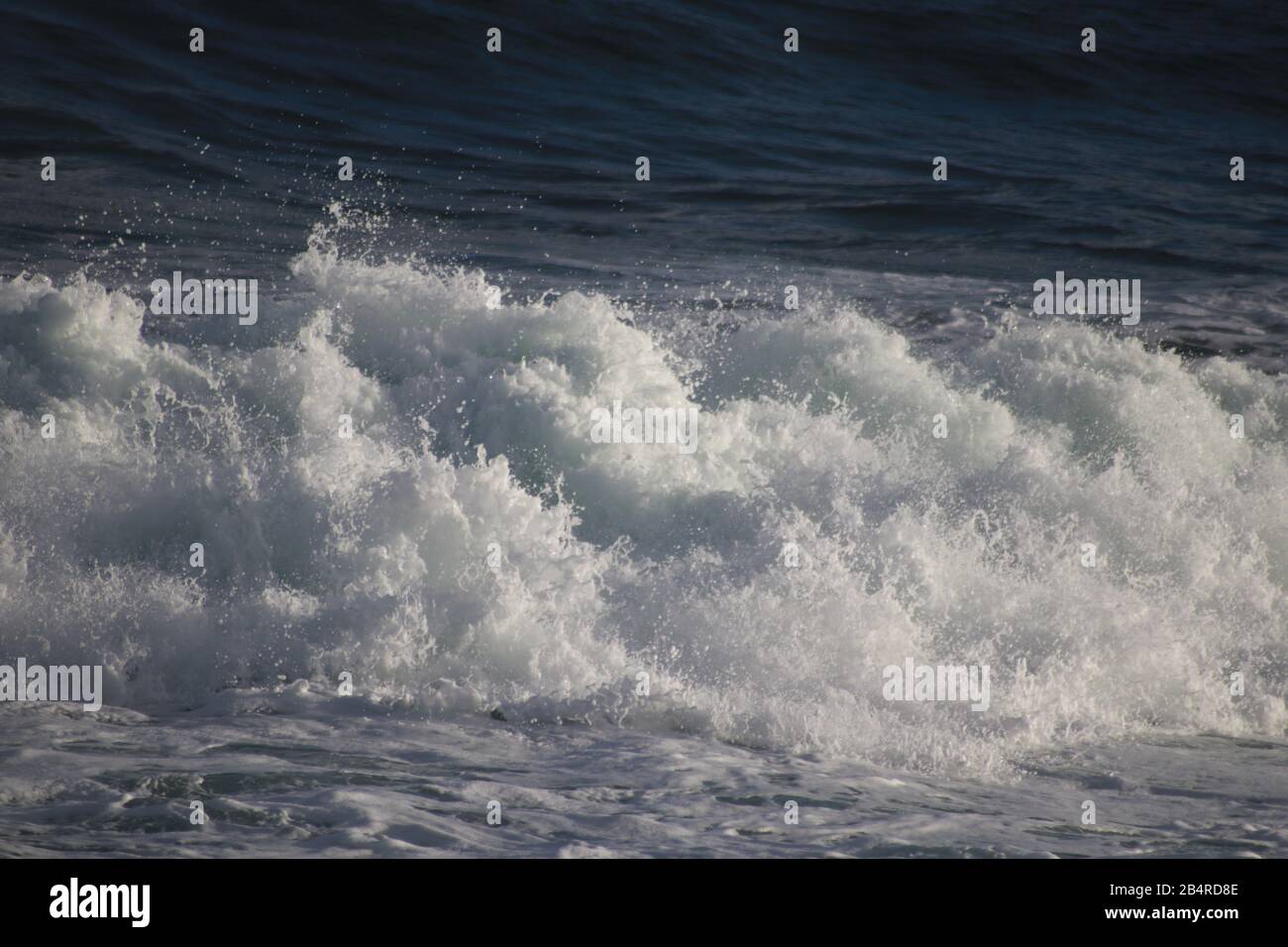 Wave breaking with surf Stock Photo - Alamy