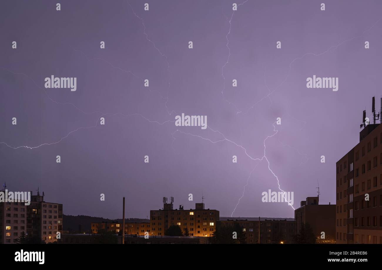 lightning over buildings at night, stribro Stock Photo - Alamy