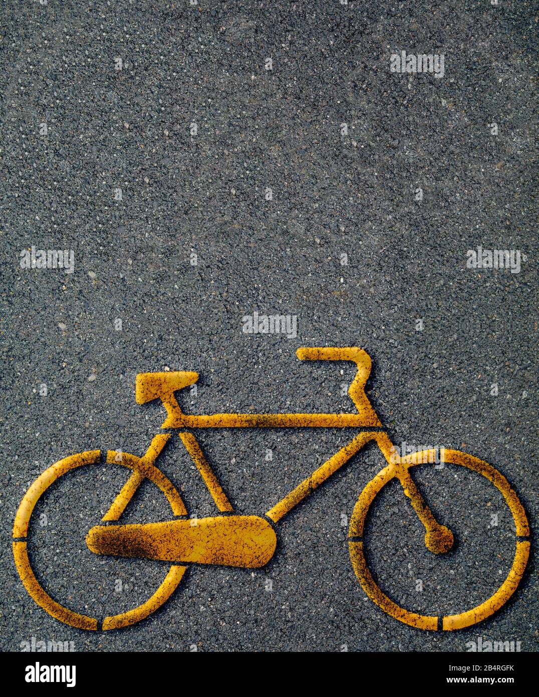 Paved cycle lane with yellow bicycle symbol Stock Photo - Alamy