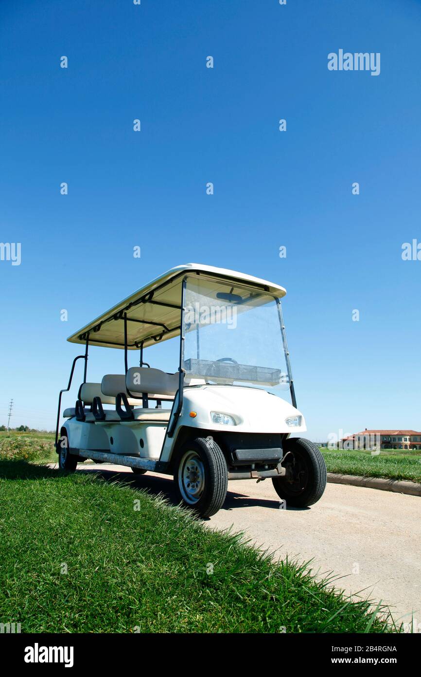 White golf carts at the green golf course Stock Photo - Alamy