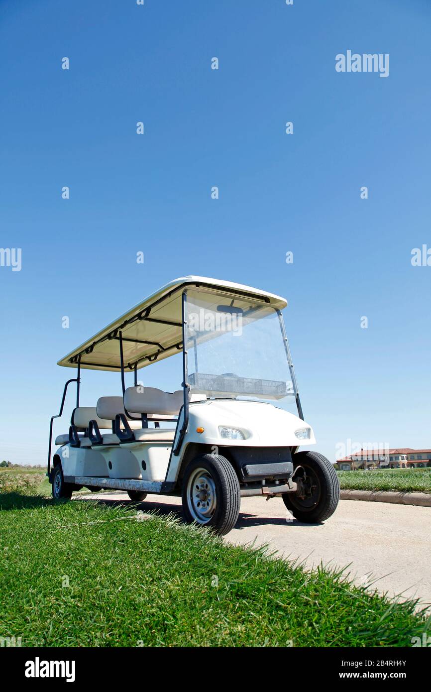 White golf carts at the green golf course Stock Photo - Alamy