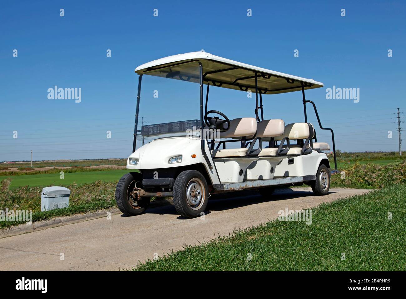 White golf carts at the green golf course Stock Photo - Alamy