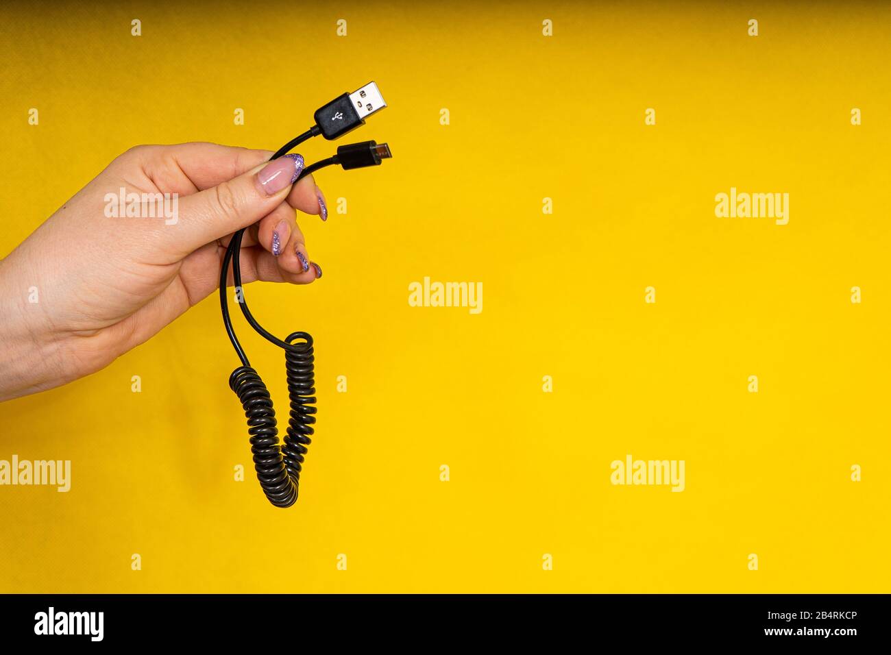 USB cable in hand close-up. Charging your phone Stock Photo - Alamy
