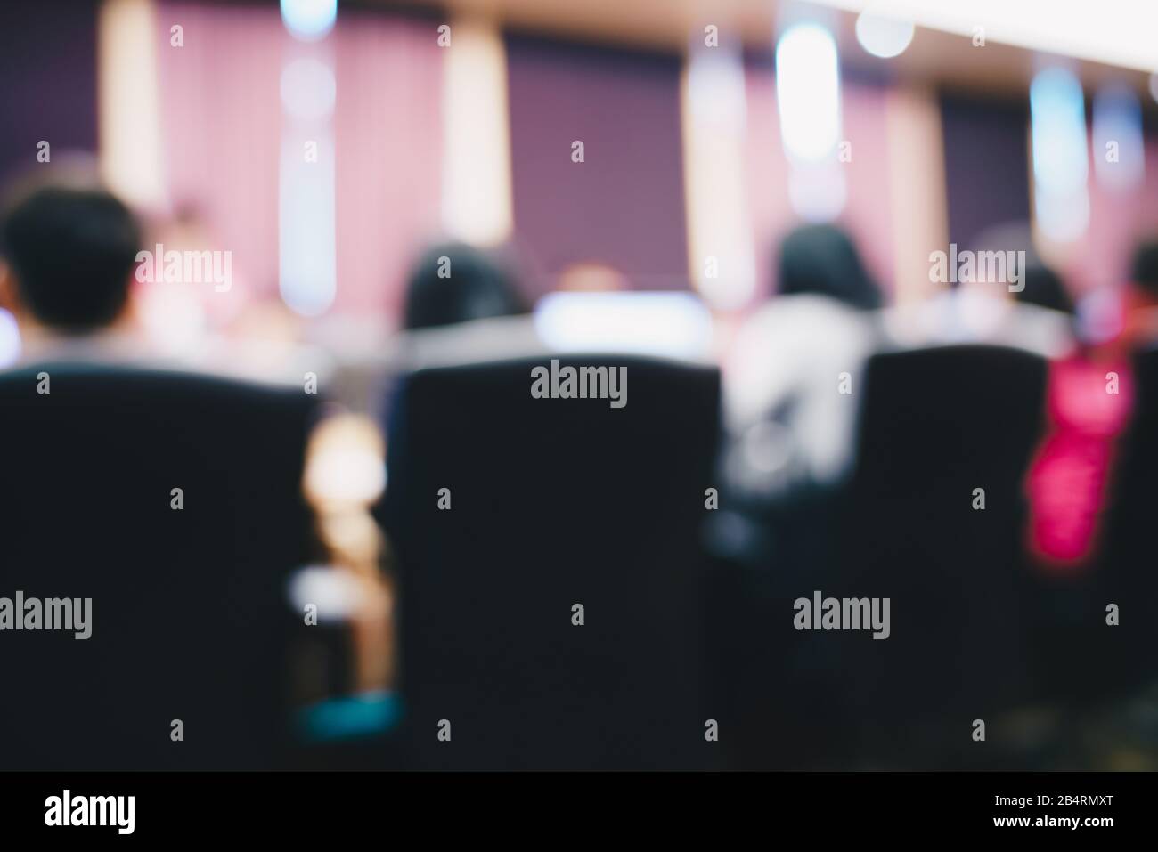 Abstract blurred people sitting in seminar conference hall room ...