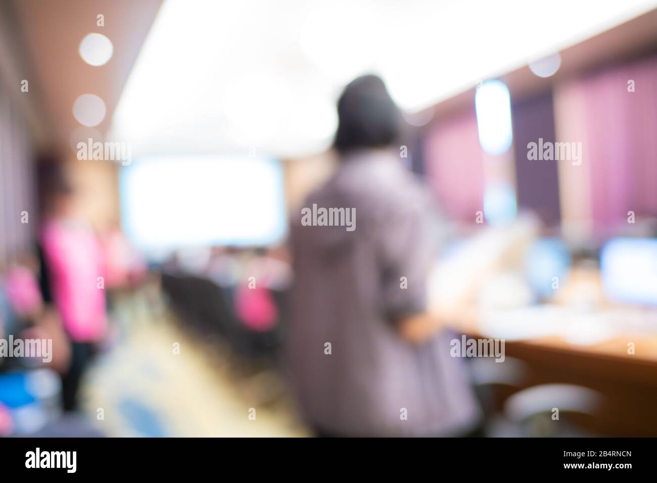 Abstract blurred people sitting in seminar conference hall room ...