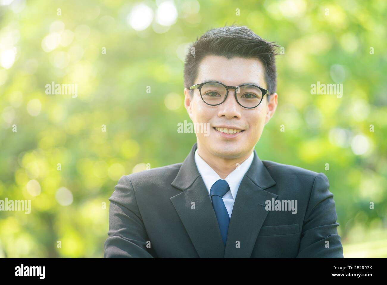 Attractive smart 30s asian business men in city public park nature ...