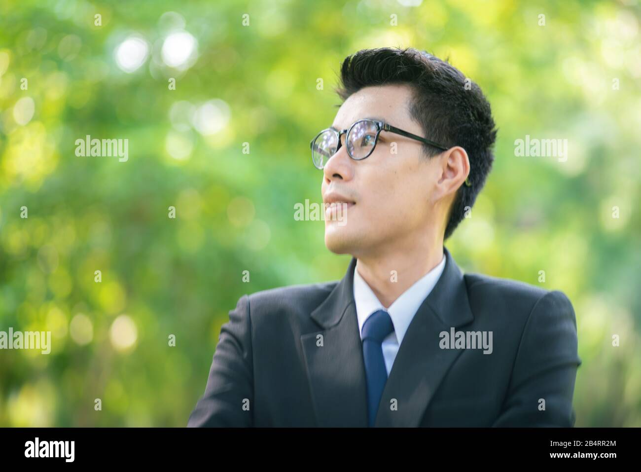 Smart business asian men with suit in green city park, Bun Stock Photo ...