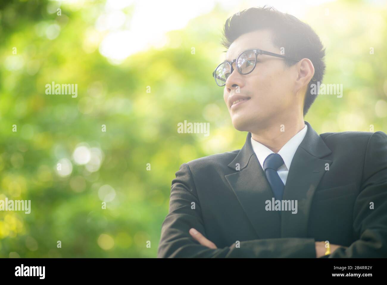 Attractive smart 30s asian business men in city public park nature ...