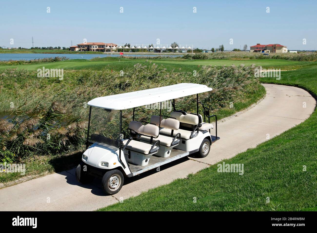 White golf carts at the green golf course Stock Photo - Alamy