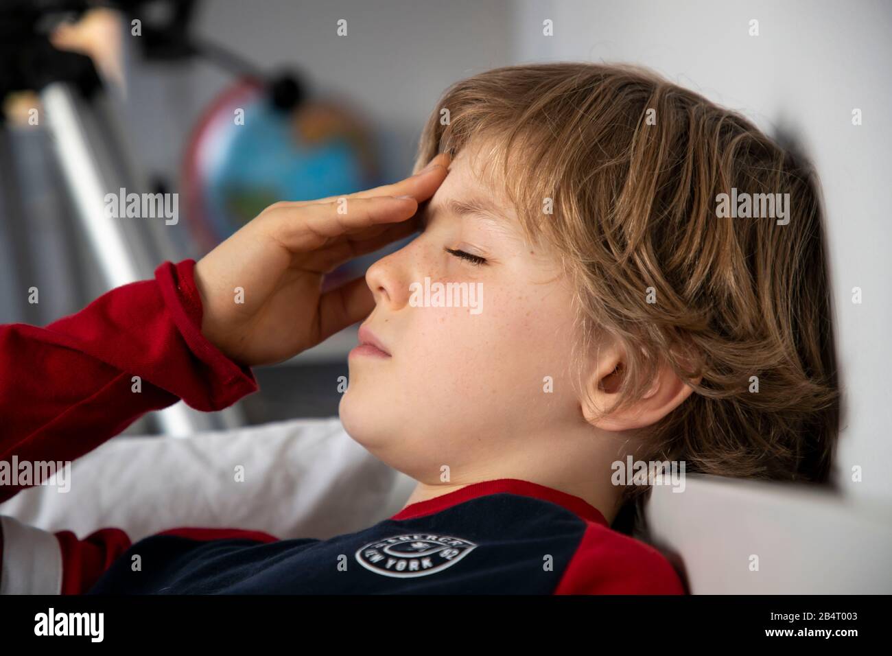 Child with headache, boy 9 years old, with pain distorted face ...