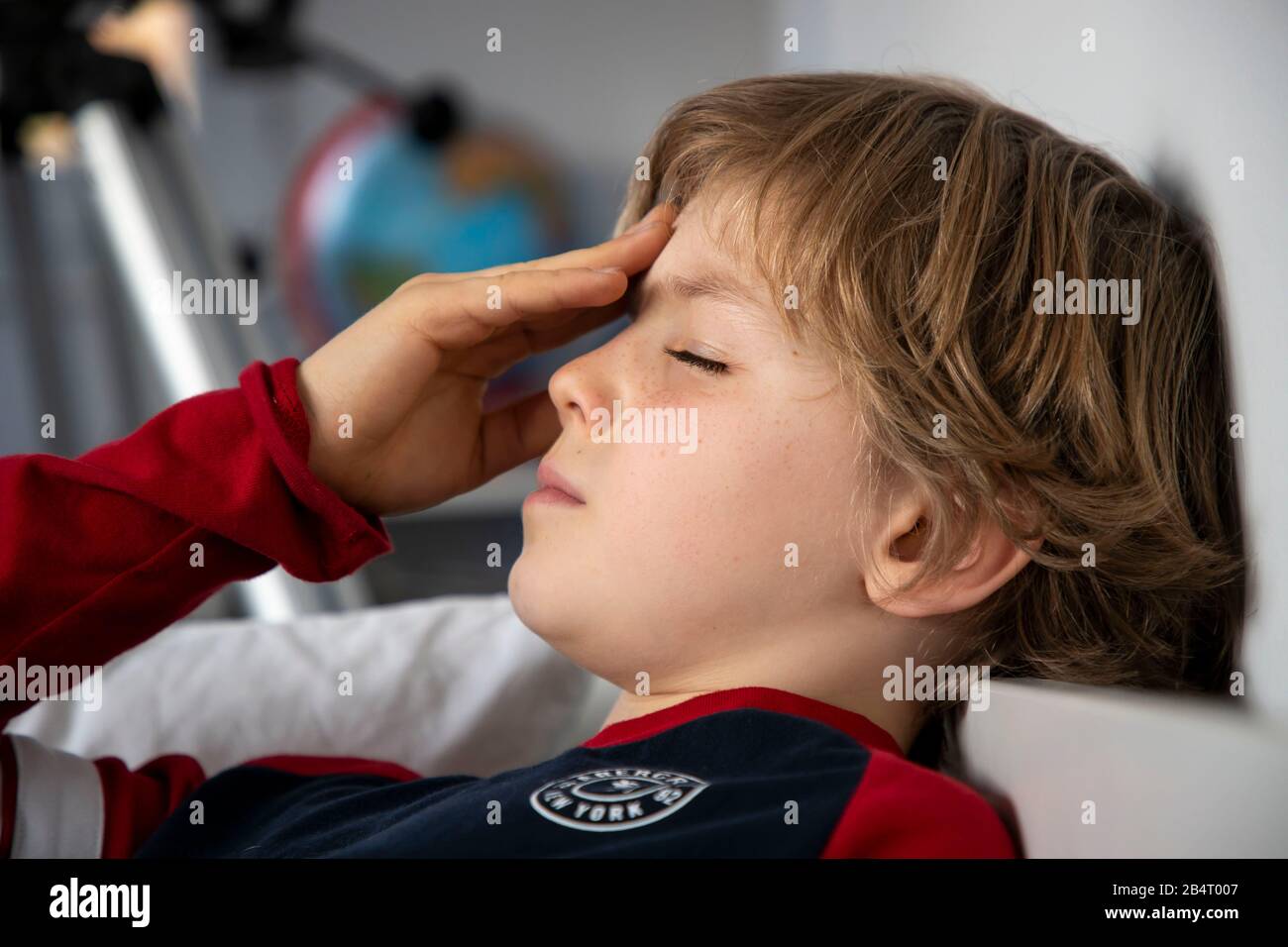 Child with headache, boy 9 years old, with pain distorted face ...
