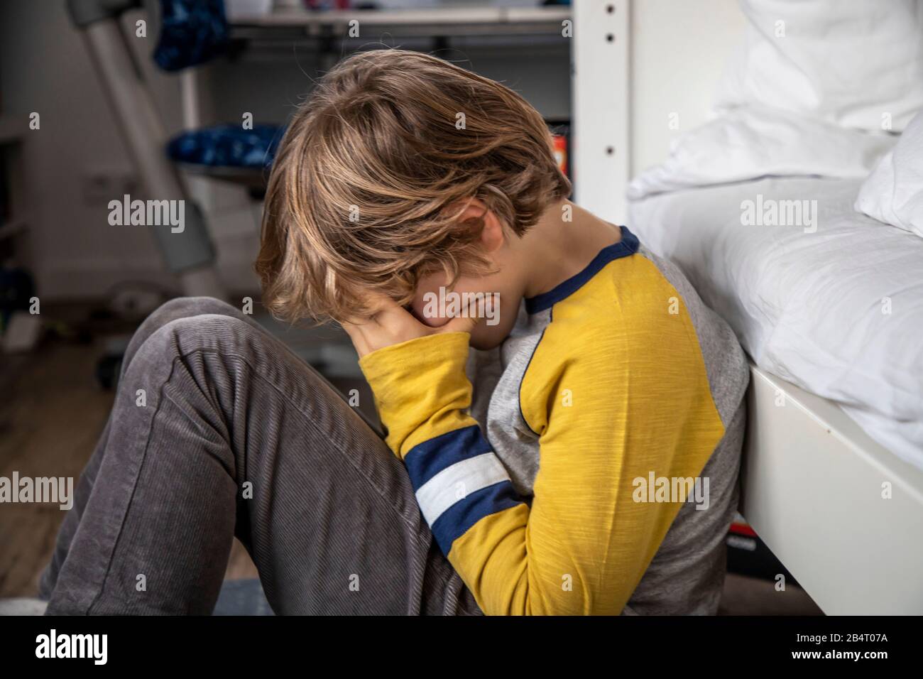 Child with headache, boy 9 years old, with pain distorted face ...