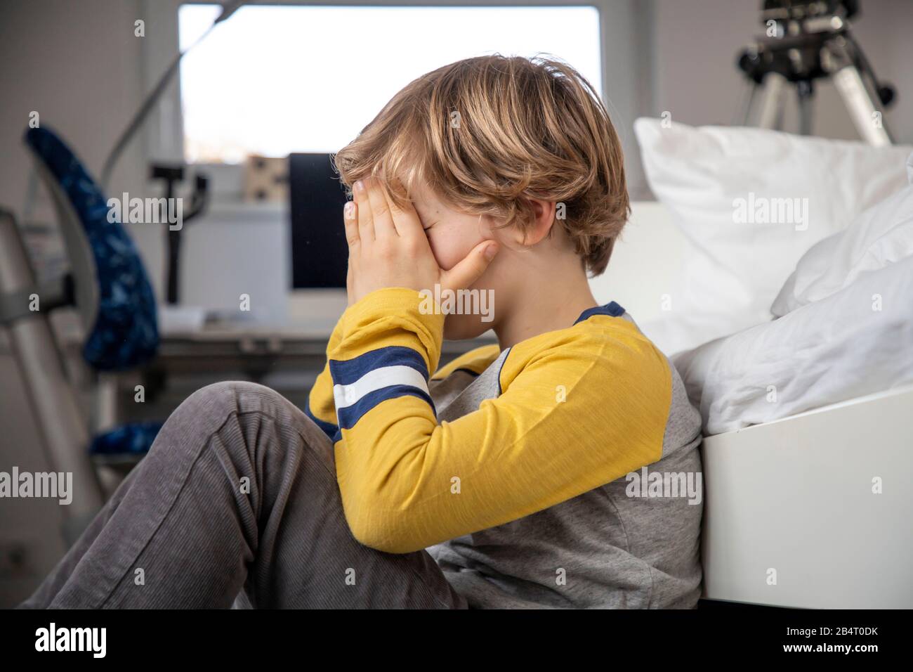 Child with headache, boy 9 years old, with pain distorted face ...