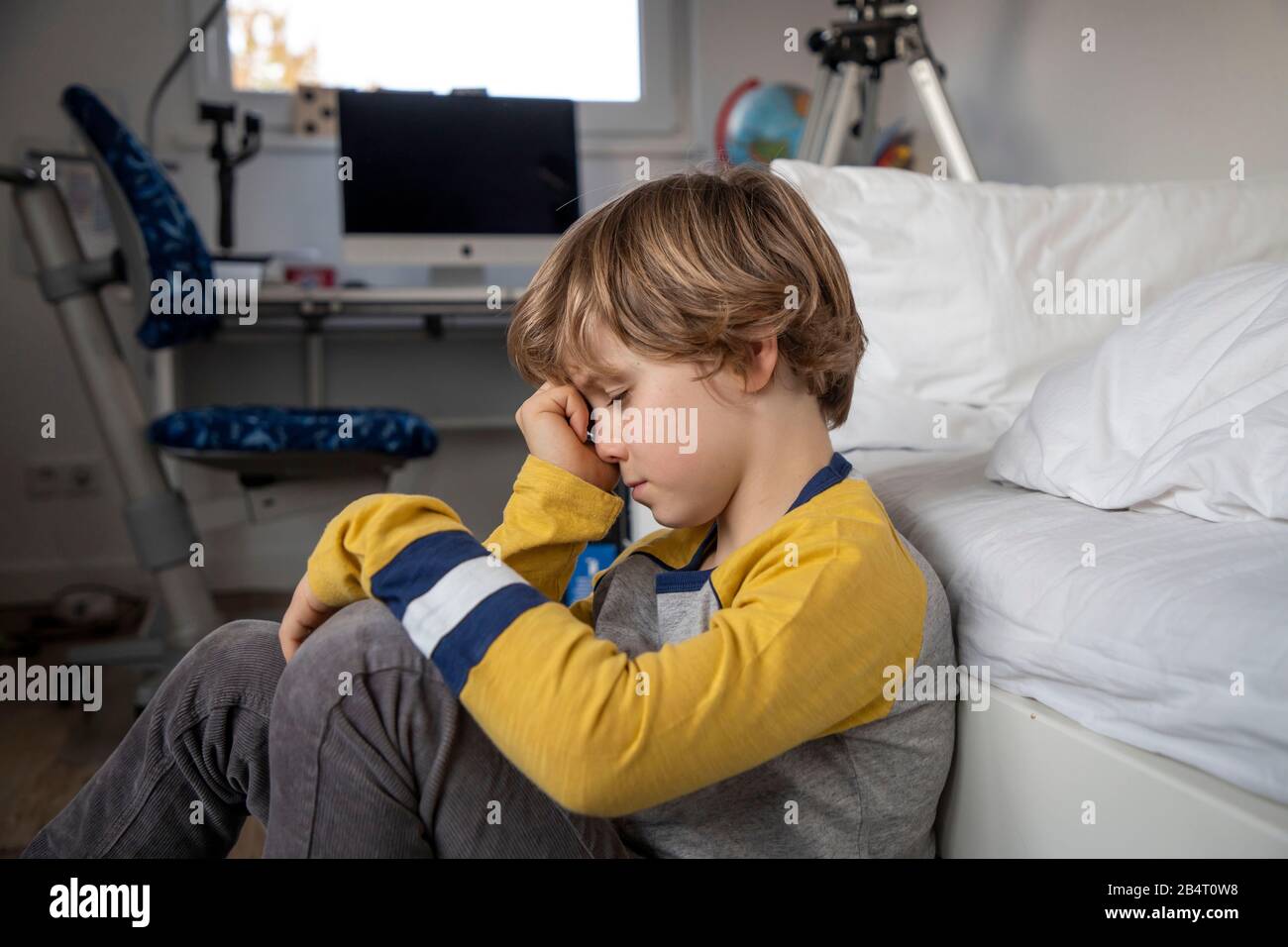 Child with headache, boy 9 years old, with pain distorted face ...