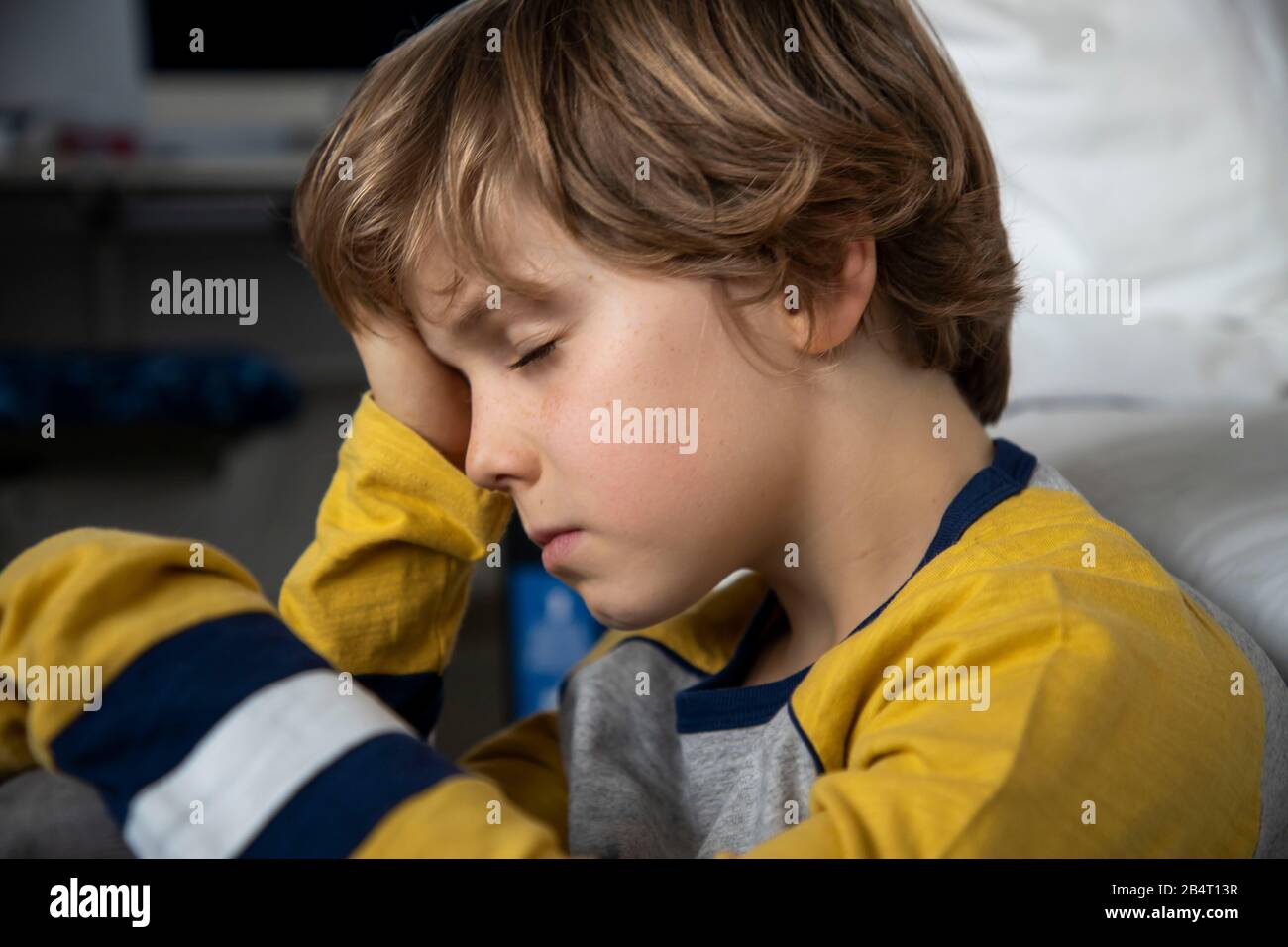 Child with headache, boy 9 years old, with pain distorted face ...