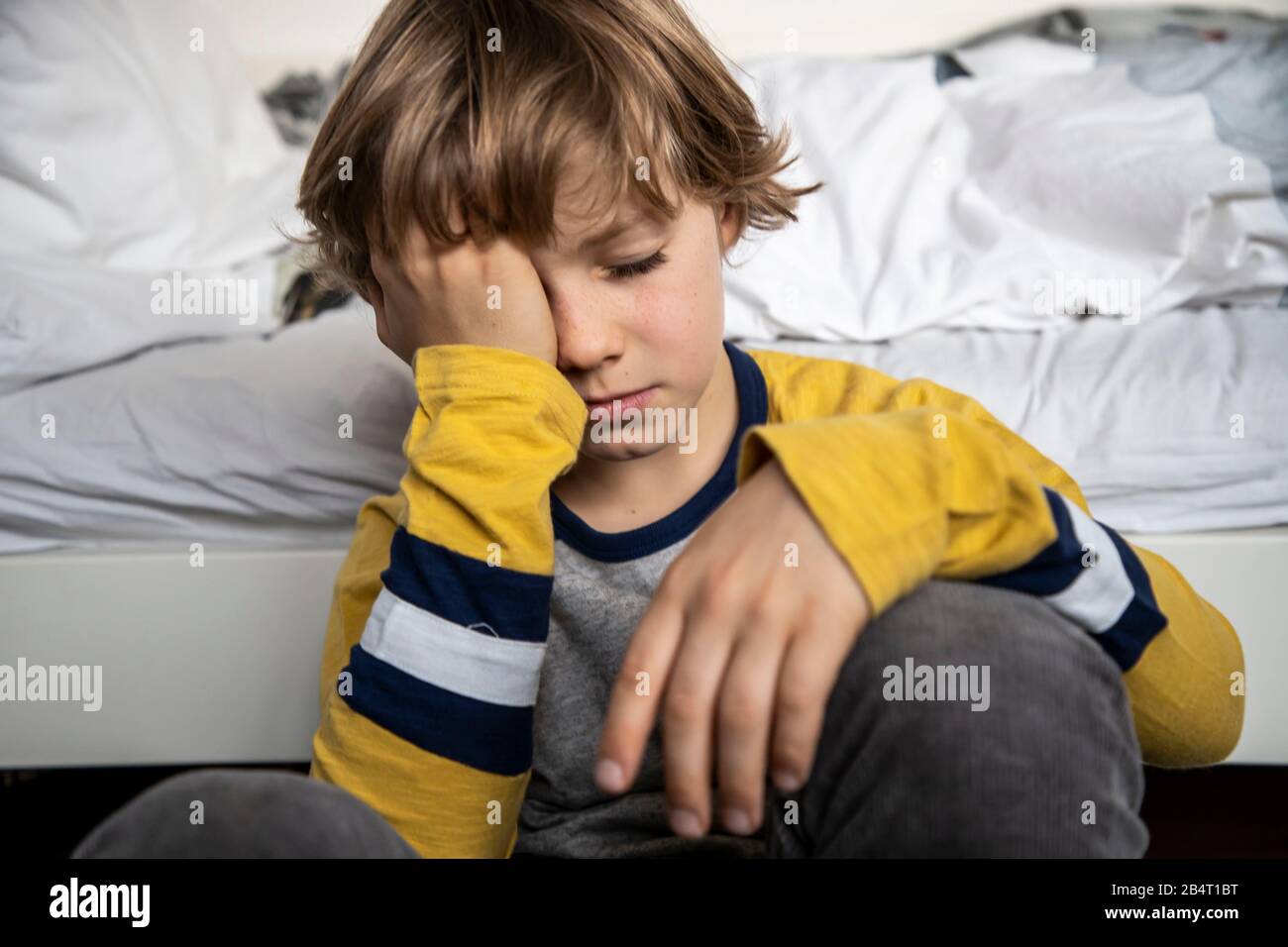 Child with headache, boy 9 years old, with pain distorted face ...