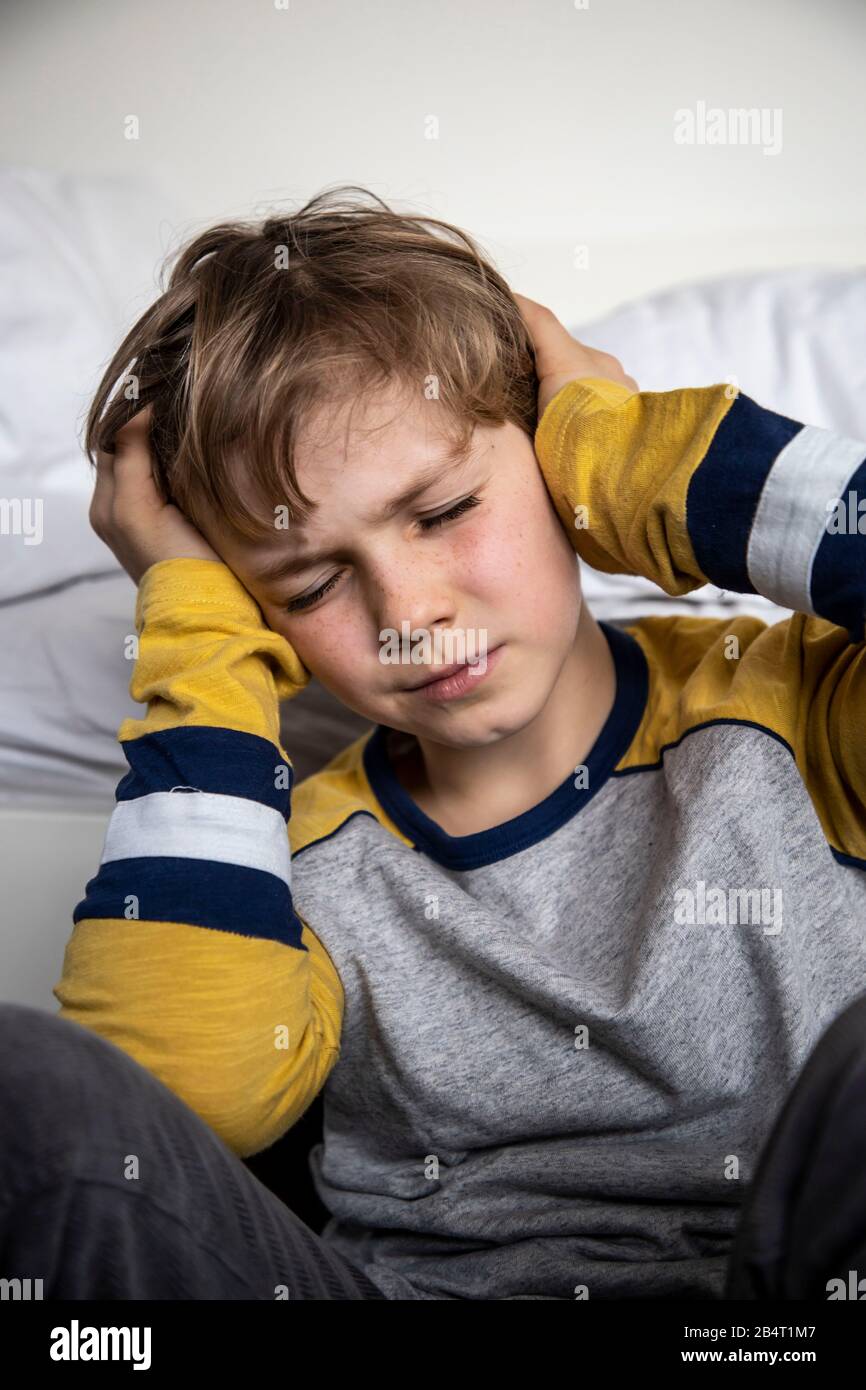 Child with headache, boy 9 years old, with pain distorted face ...