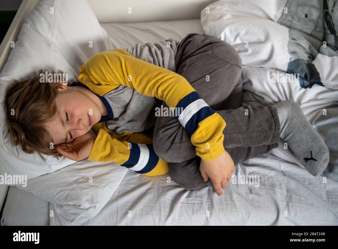 Child with headache, boy 9 years old, with pain distorted face ...