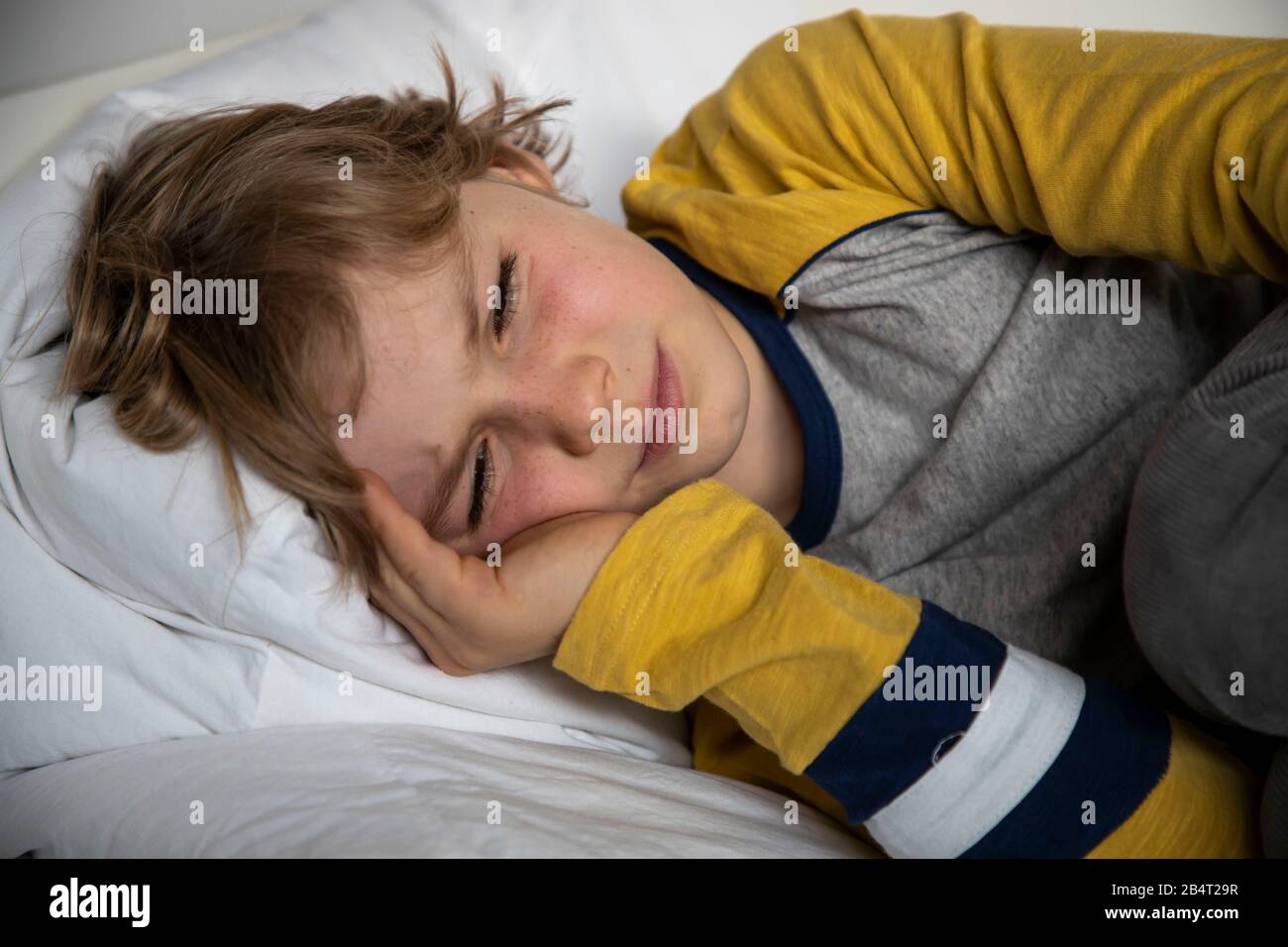 Child with headache, boy 9 years old, with pain distorted face ...
