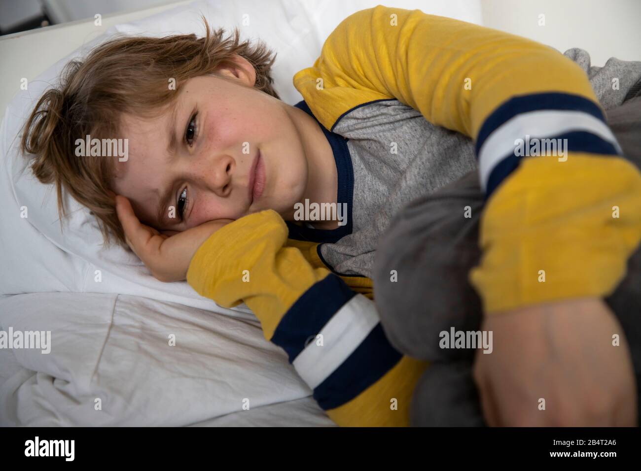 Child with headache, boy 9 years old, with pain distorted face ...