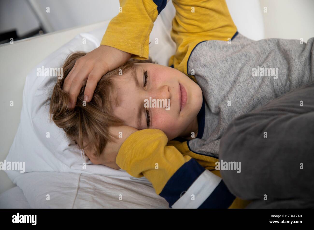 Child with headache, boy 9 years old, with pain distorted face ...