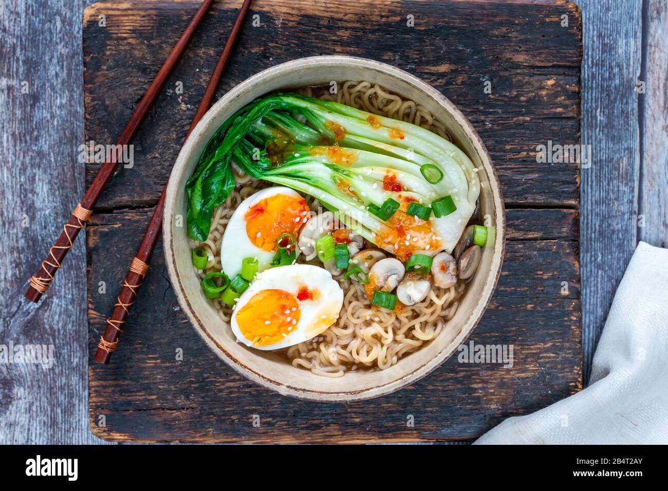 Japanese sesame ramen noodles with pok choi, boiled egg, mushrooms ...