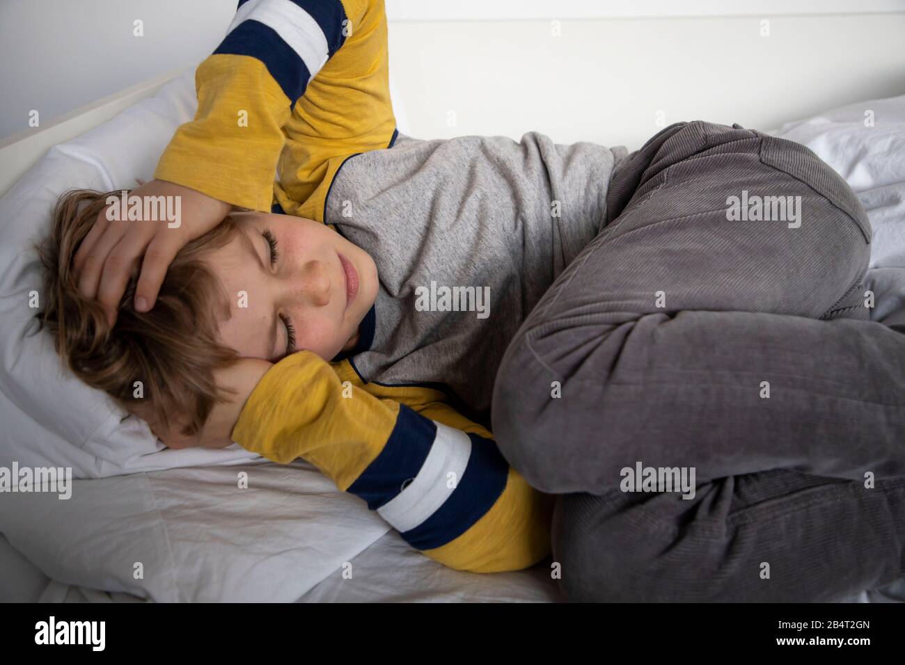 Child with headache, boy 9 years old, with pain distorted face ...