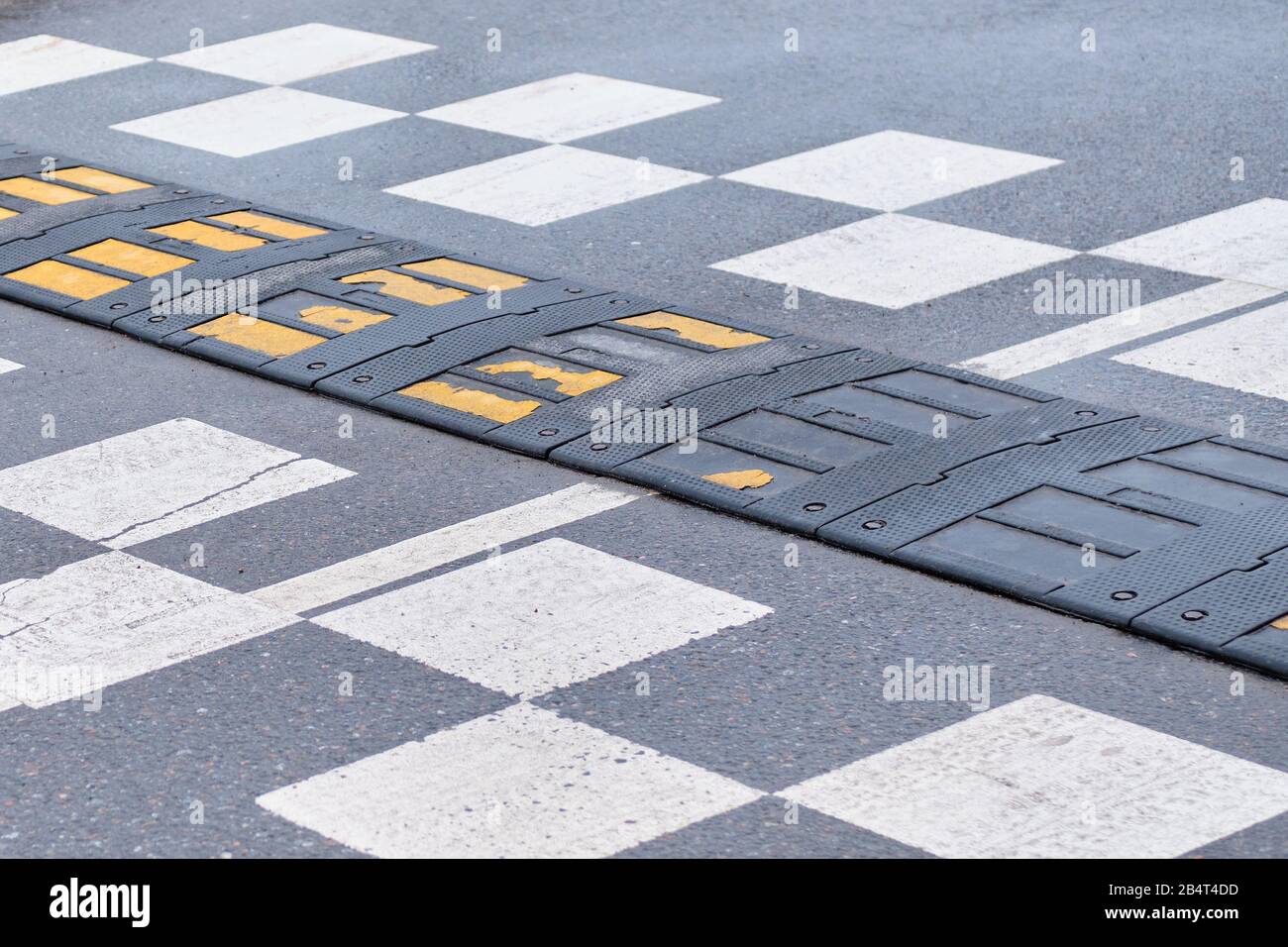 Speed bump on the pavement. Close up Stock Photo - Alamy