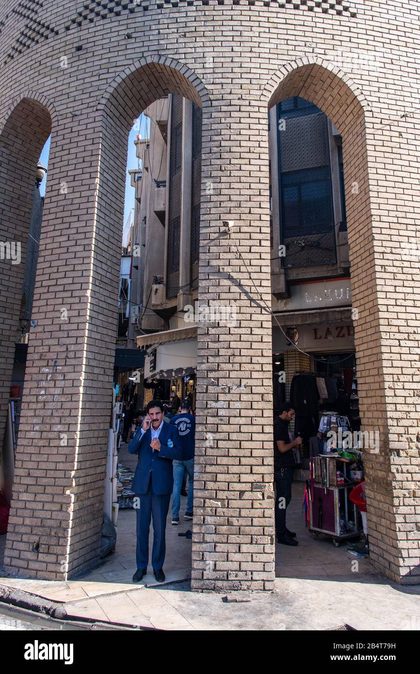 Iraq, Iraqi Kurdistan, Arbil, Erbil. a man stands under an arch in ...