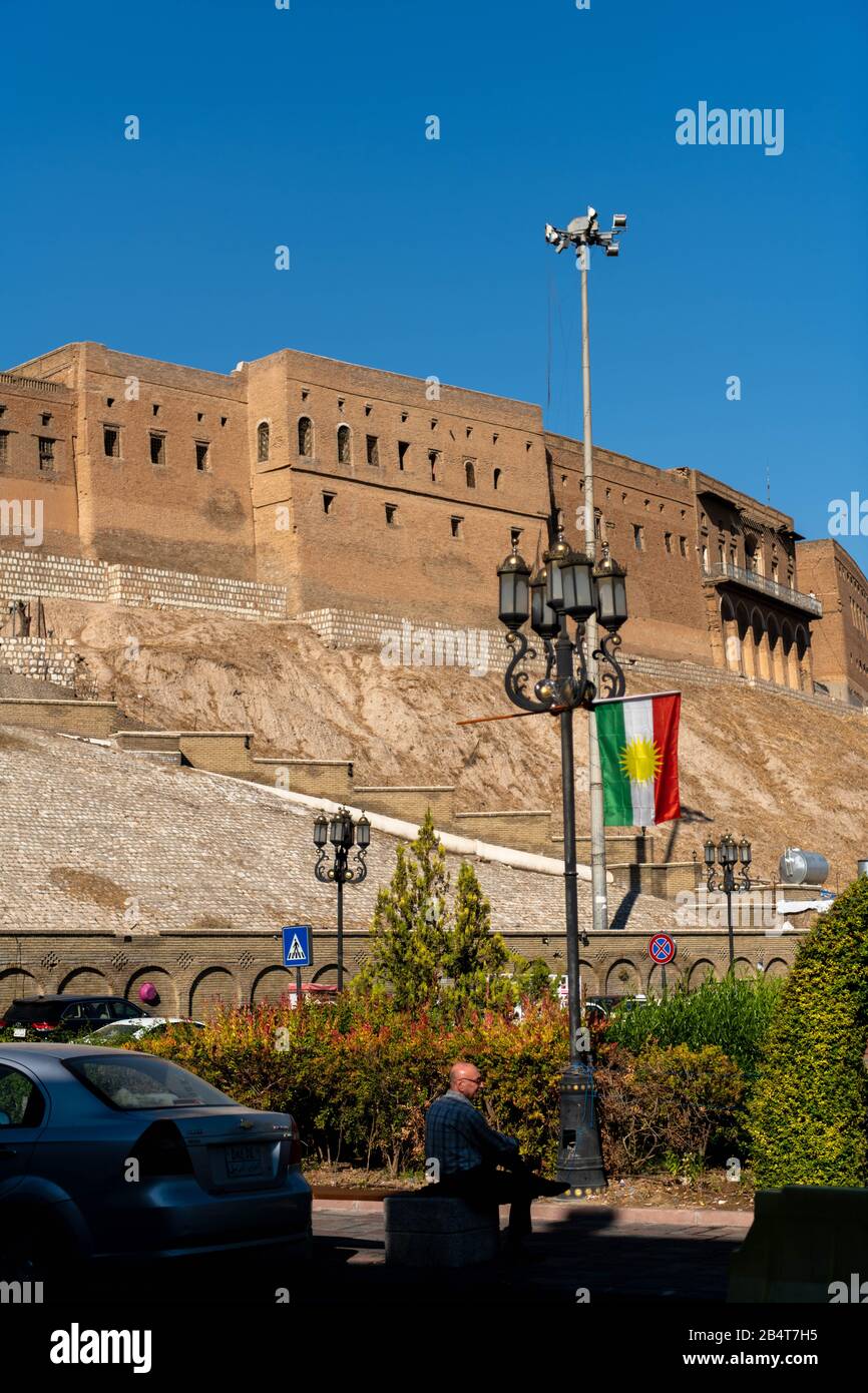 A man sits on a plot down the Qalat citadel in Erbil Stock Photo - Alamy