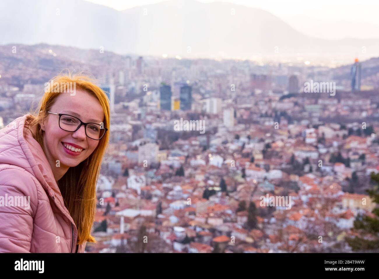 Girl smilling above the cityscape of Sarajevo capital of Bosnia and ...