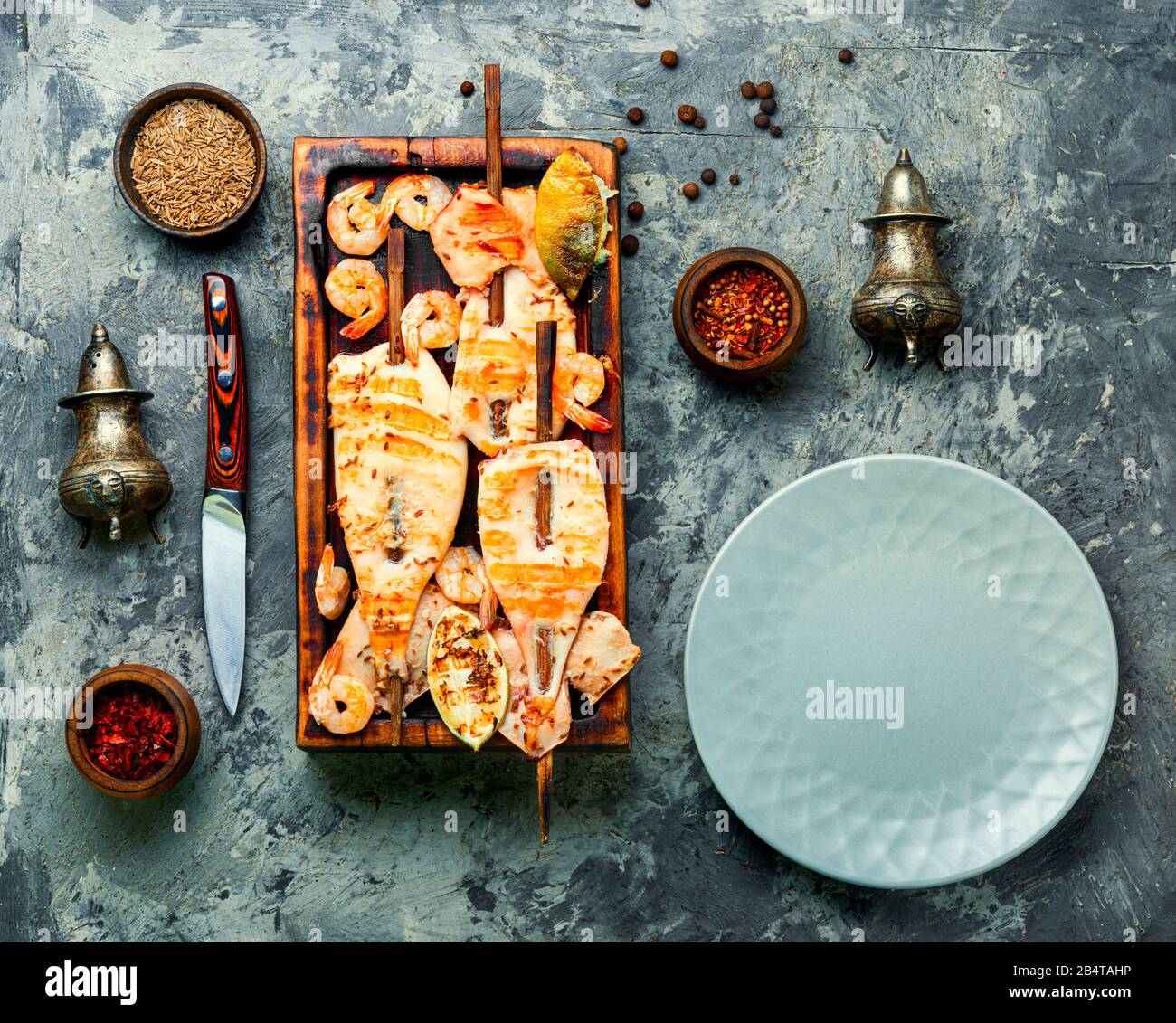 Grilled squid skewers on a kitchen board.Grilled calamari Stock Photo ...