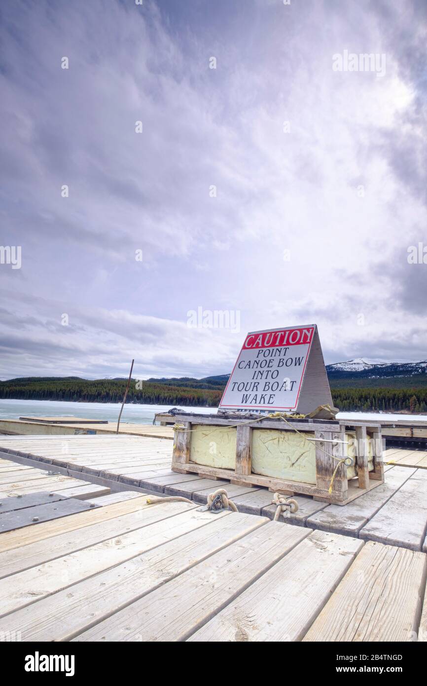 Caution point canoe bow into tour boat wake sign Stock Photo - Alamy