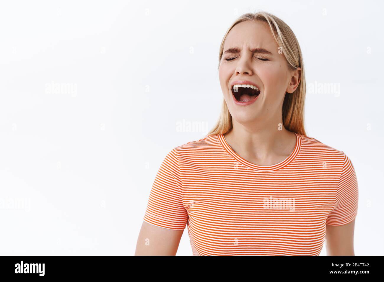 Miserable sad young whining blond girl acting immature, close eyes and ...