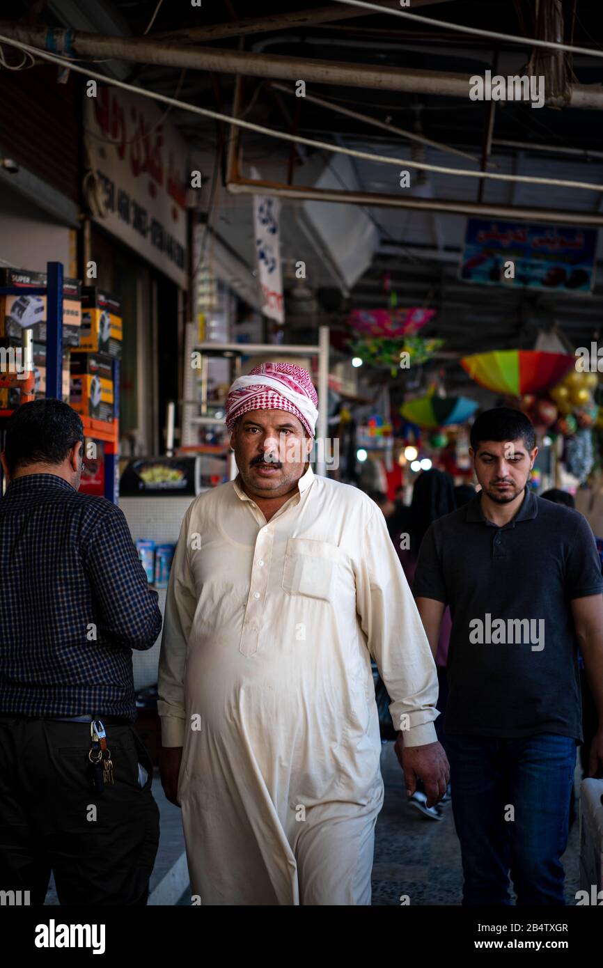 Iraq, Iraqi Kurdistan, Arbil, Erbil. Next to Erbil's bazar a man is ...