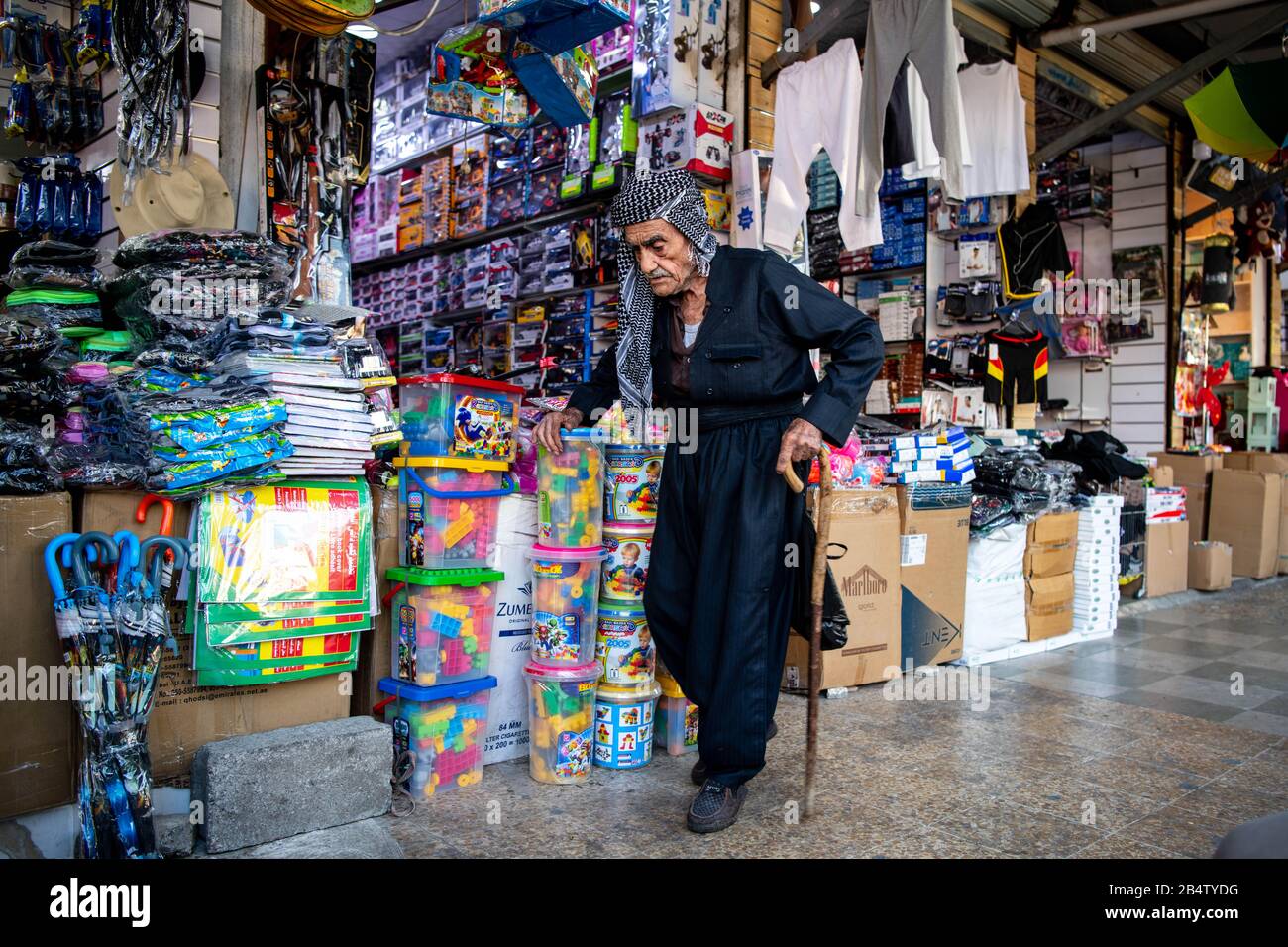 Iraq, Iraqi Kurdistan, Arbil, Erbil. In fornt of a children toys store in Erbil, an elderly is ...