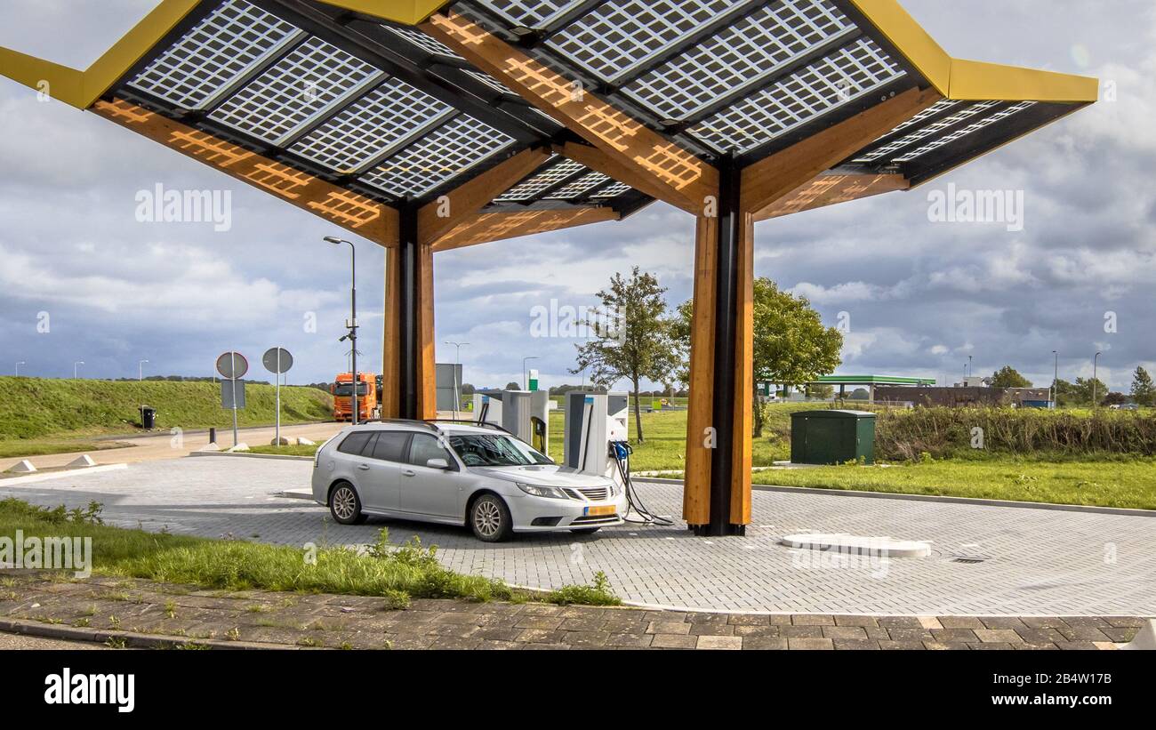 Electric car filling at electricity charge station in the fast ...