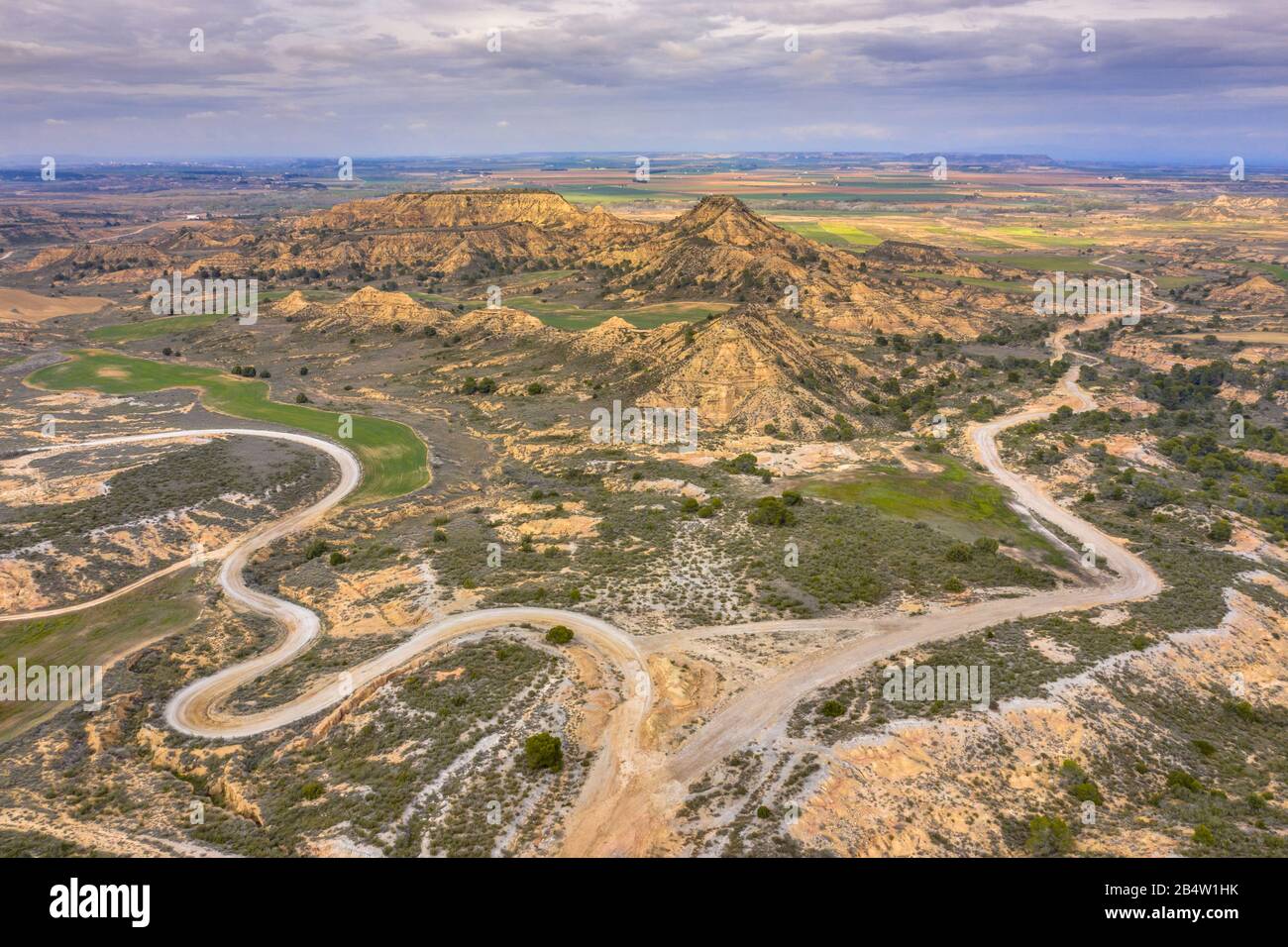 Aerial view of dirt road through arid landscape of Castejon de Monegros ...
