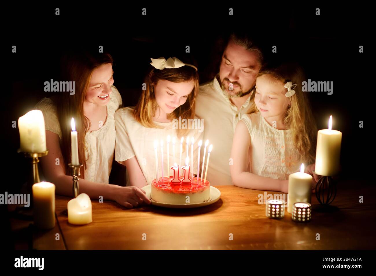 Cute Eleven Years Old Girl Making A Wish Before Blowing Candles On Her