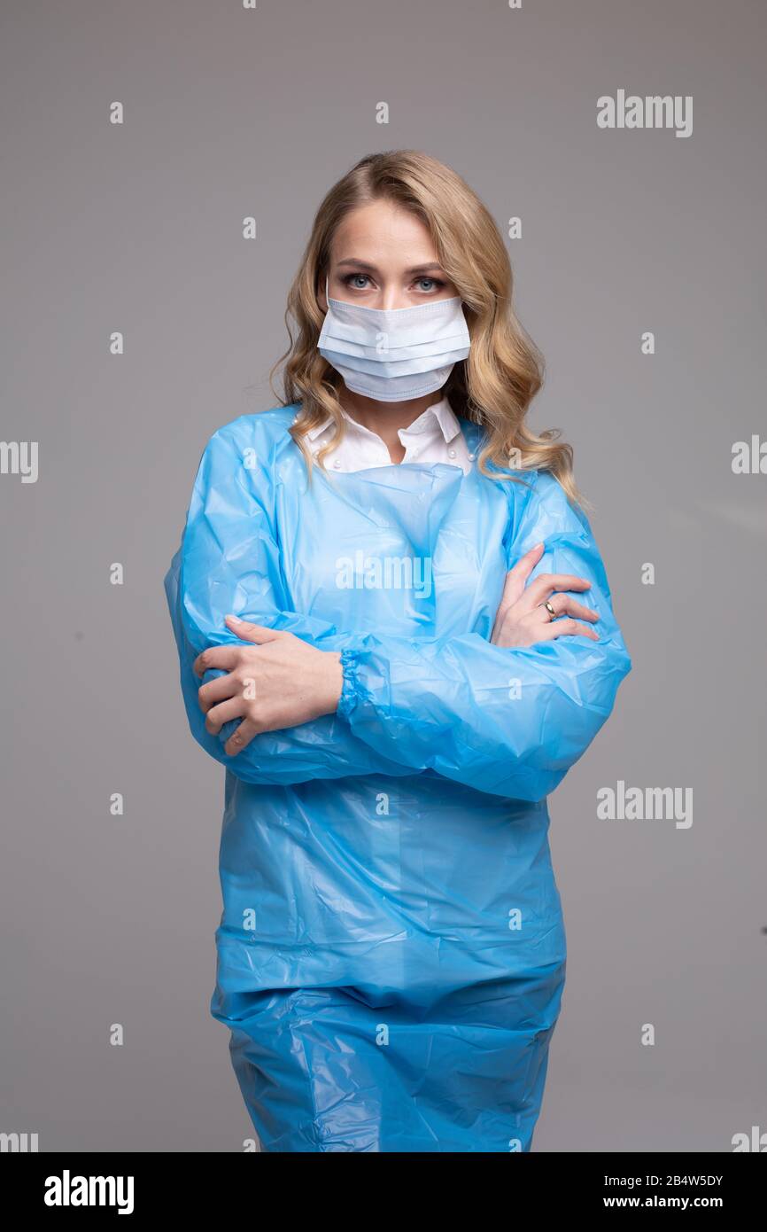 Doctor in safety robe and protection mask Stock Photo - Alamy