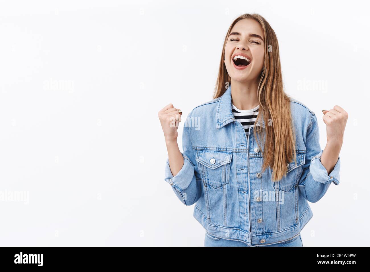 Happy and relieved young free girl feel empowered and joyful, fist pump ...