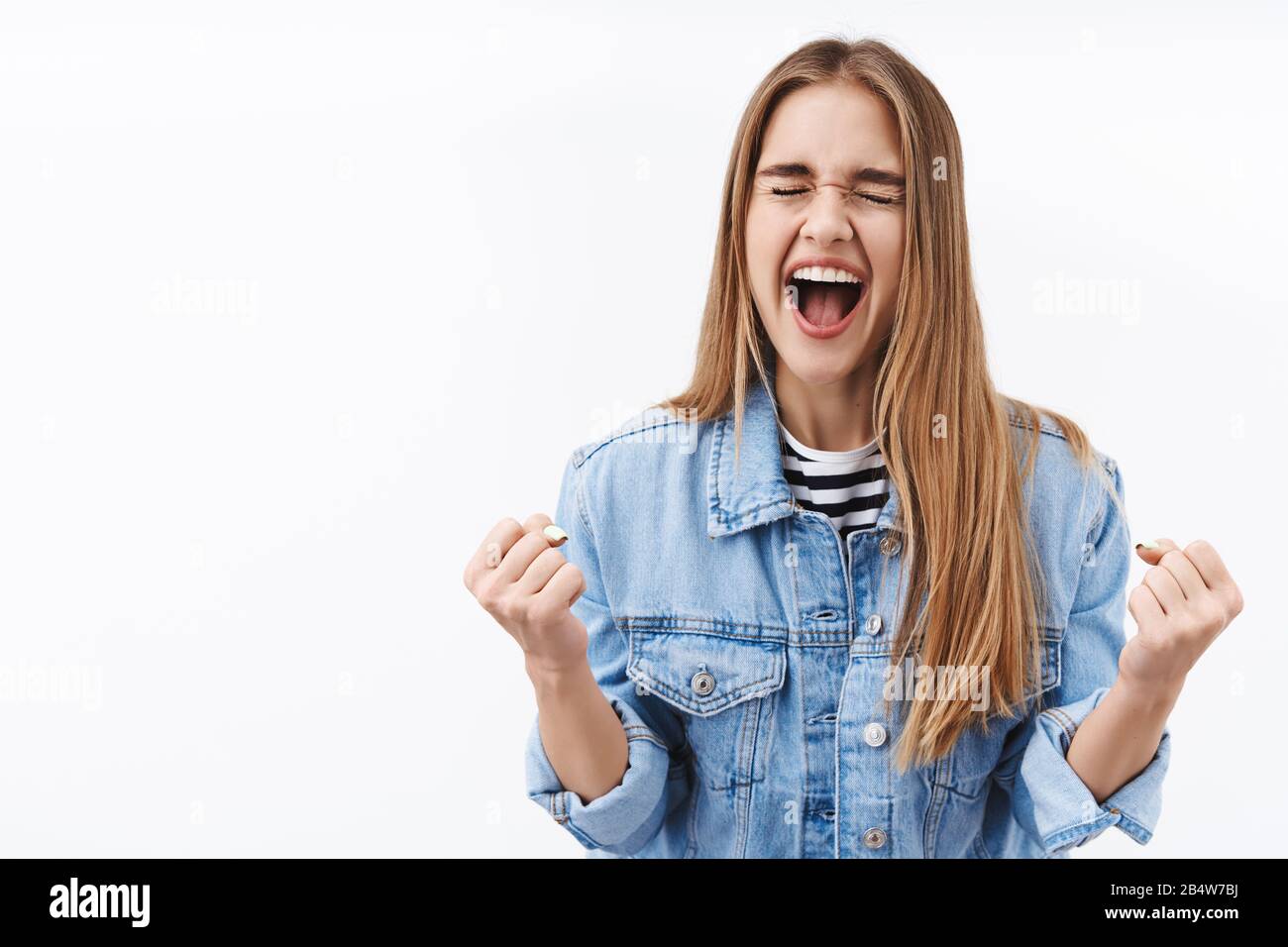 Celebration, achievement and goals concept. Upbeat happy blond girl ...
