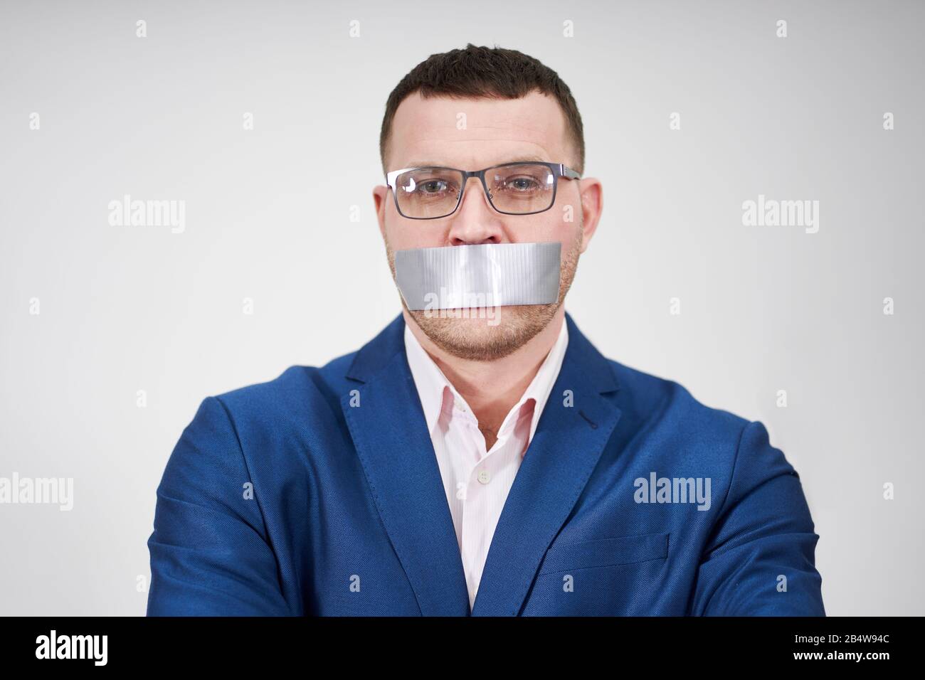 man has a big piece of black industrial tape covering his mouth, silence concept Stock Photo - Alamy