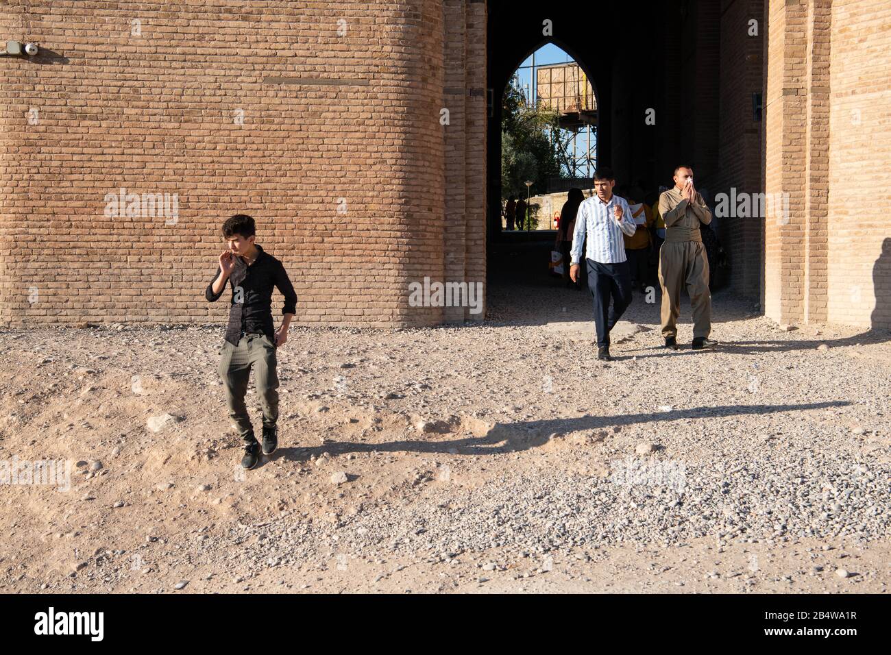 Iraq, Iraqi Kurdistan, Arbil, Erbil. A man is smoking in front of Qalat ...