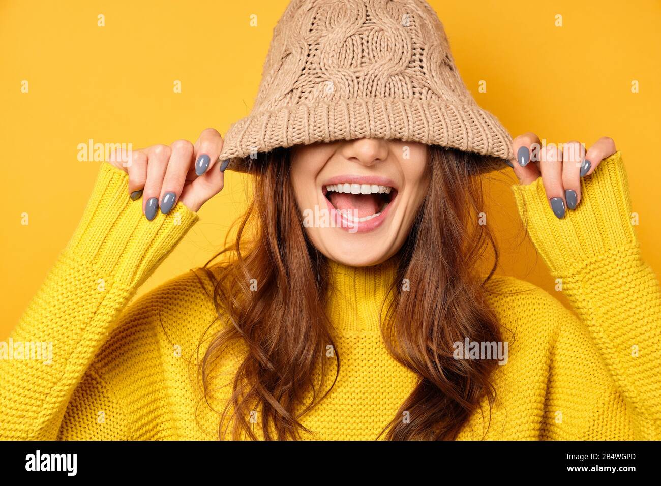 Woman pulling sweater over face hi-res stock photography and images - Alamy