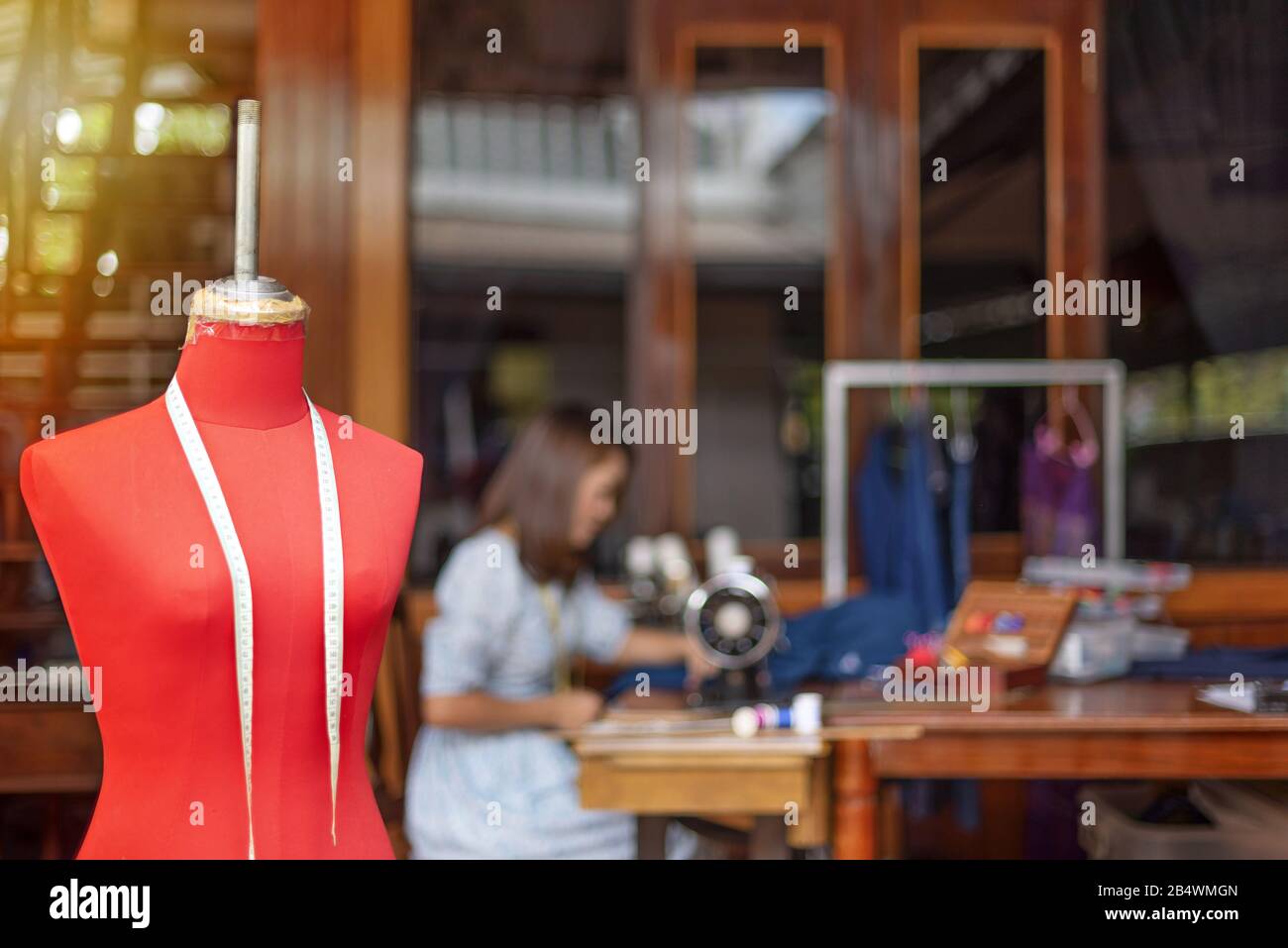 Red dummy with measuring tape in tailors studio. sewing workshop Stock ...