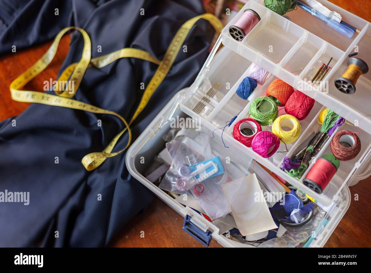 sewing tools and reels of color thread on table. Handmade clothes ...