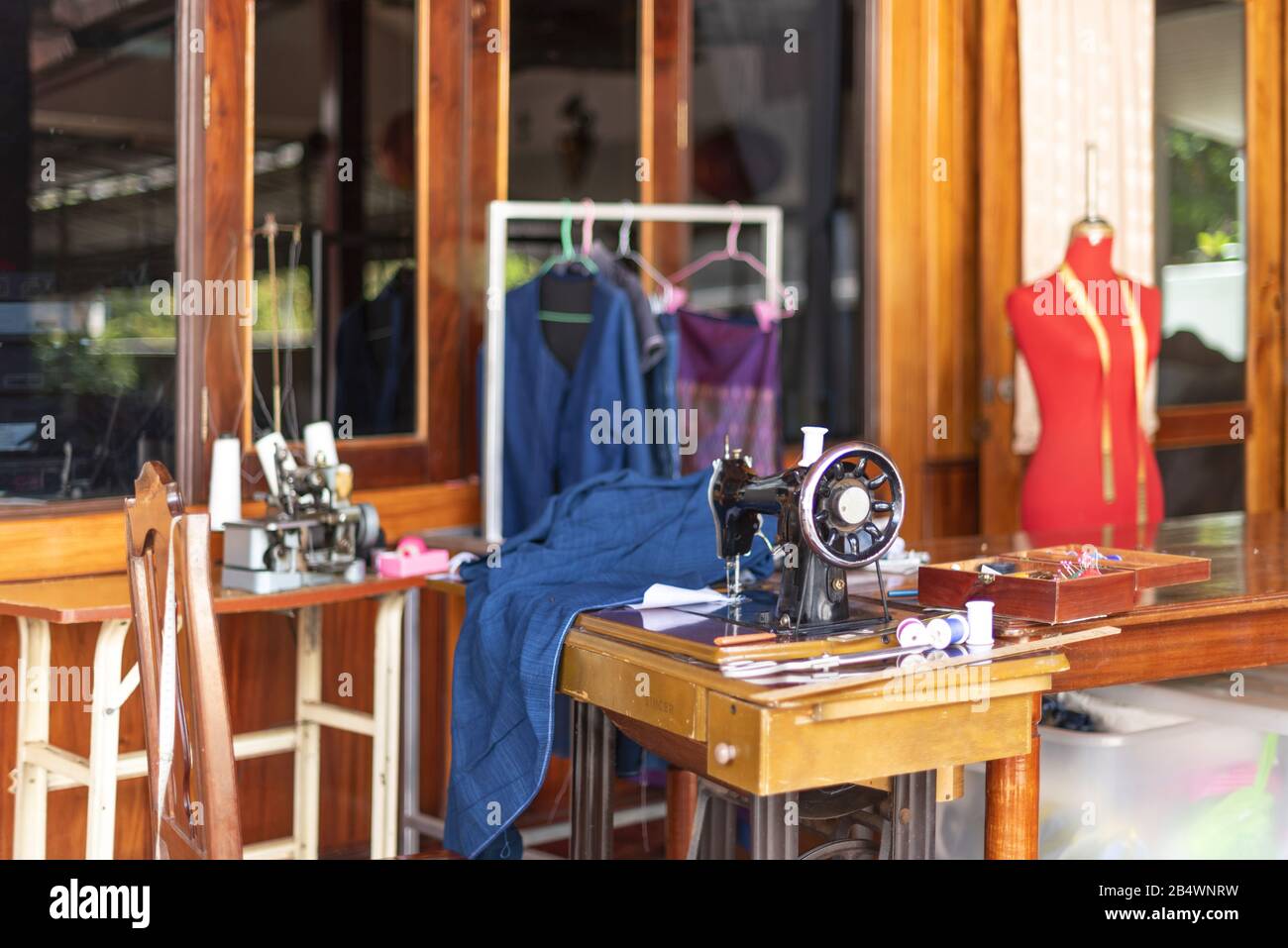 sewing tools and reels of color thread on table. Handmade clothes ...