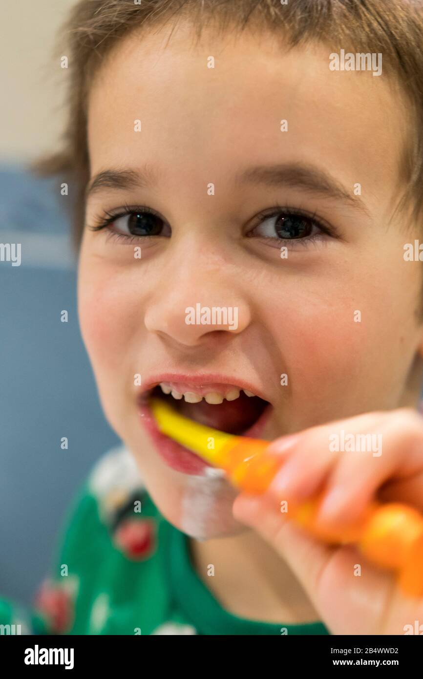 Happy little boy brushing his teeth. Oral hygiene concept. close up ...