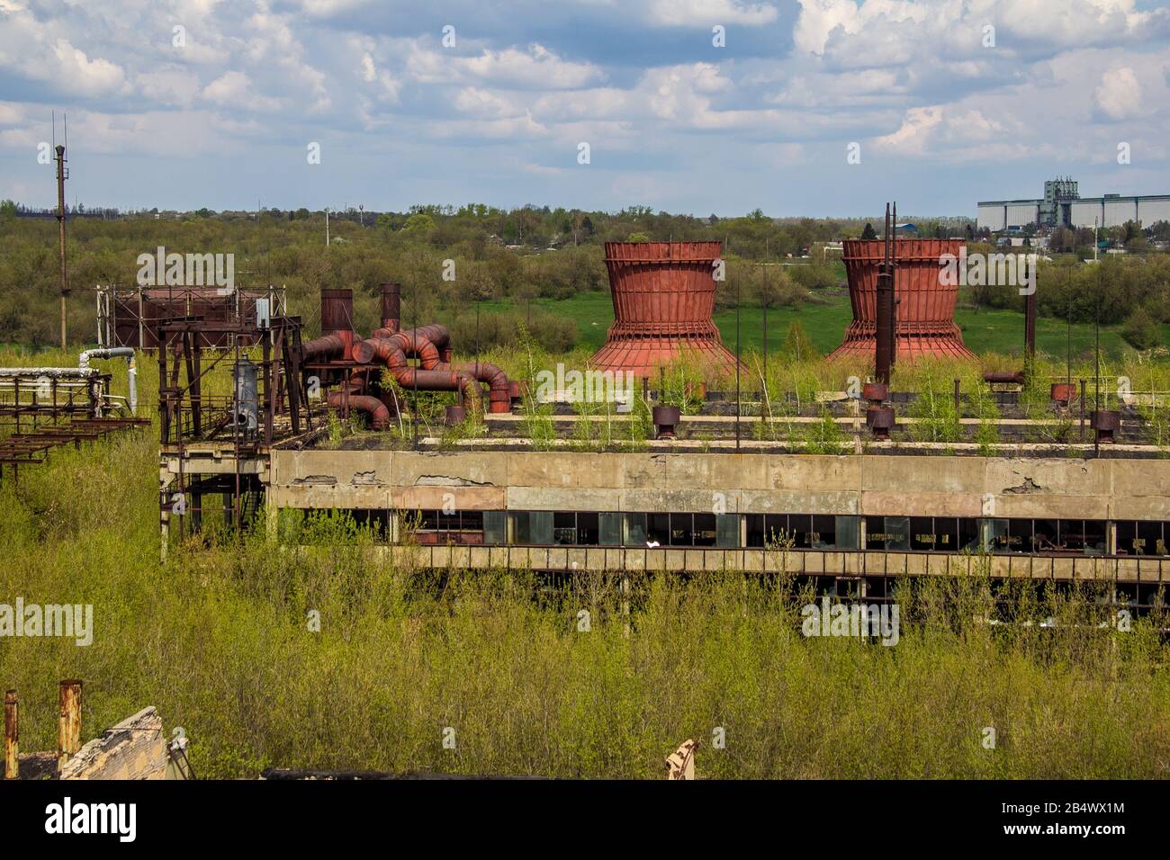 Old rusty overgrown abandoned industrial area Stock Photo - Alamy